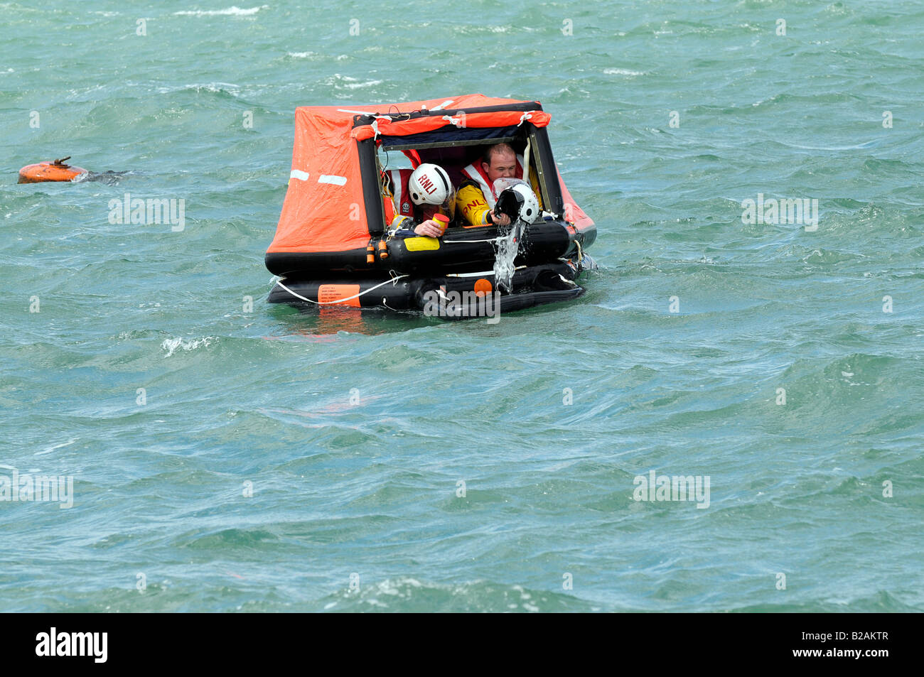 RNLI Crew members aboard an inflatable liferaft during a rescue ...