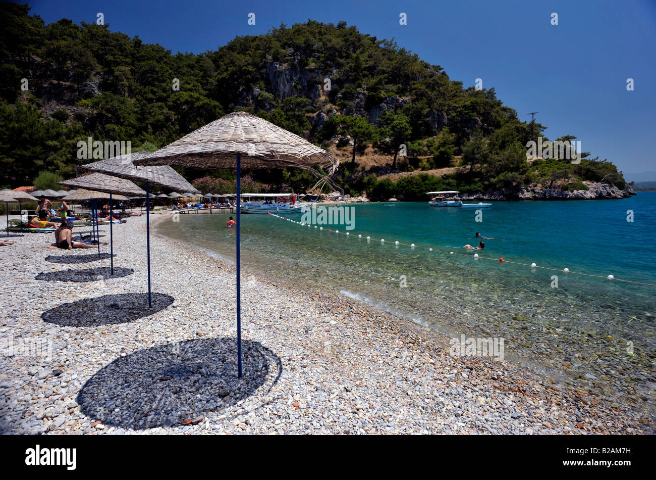 Parasols on pebbled Cinar beach Akyaka Turkey Stock Photo - Alamy