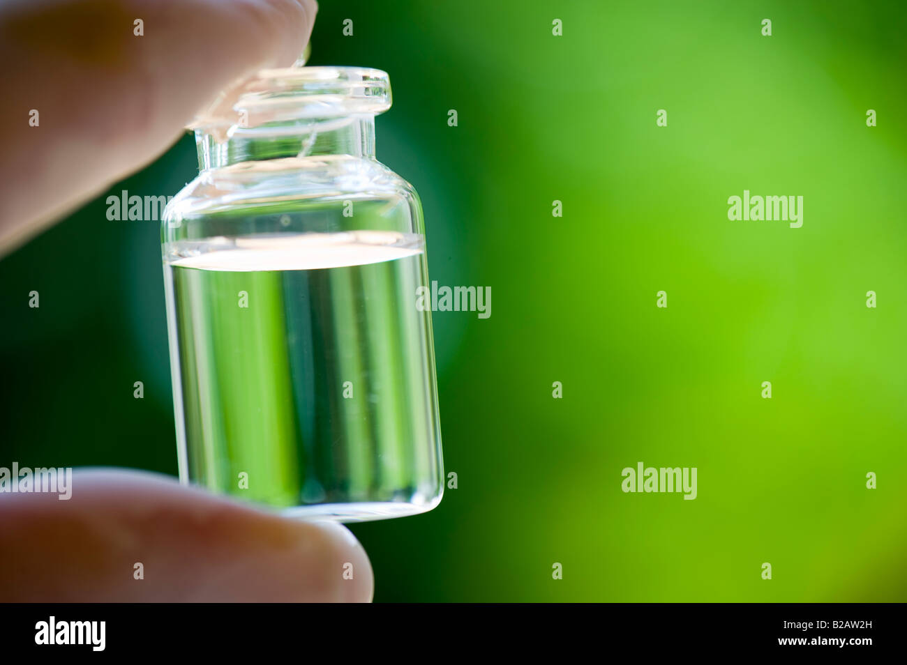 hand holding small vial outdoors Stock Photo - Alamy