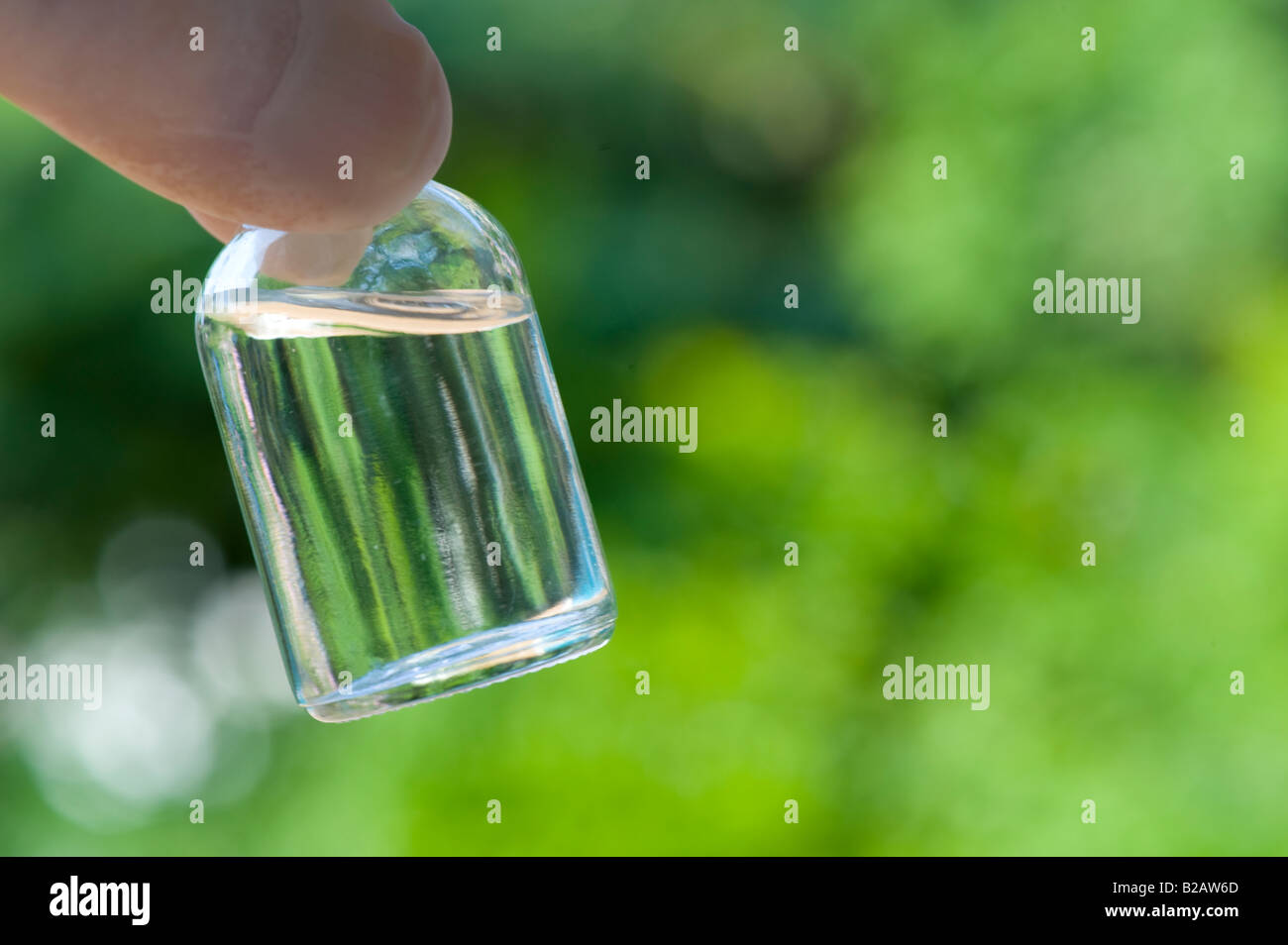 hand holding small vial outdoors Stock Photo - Alamy