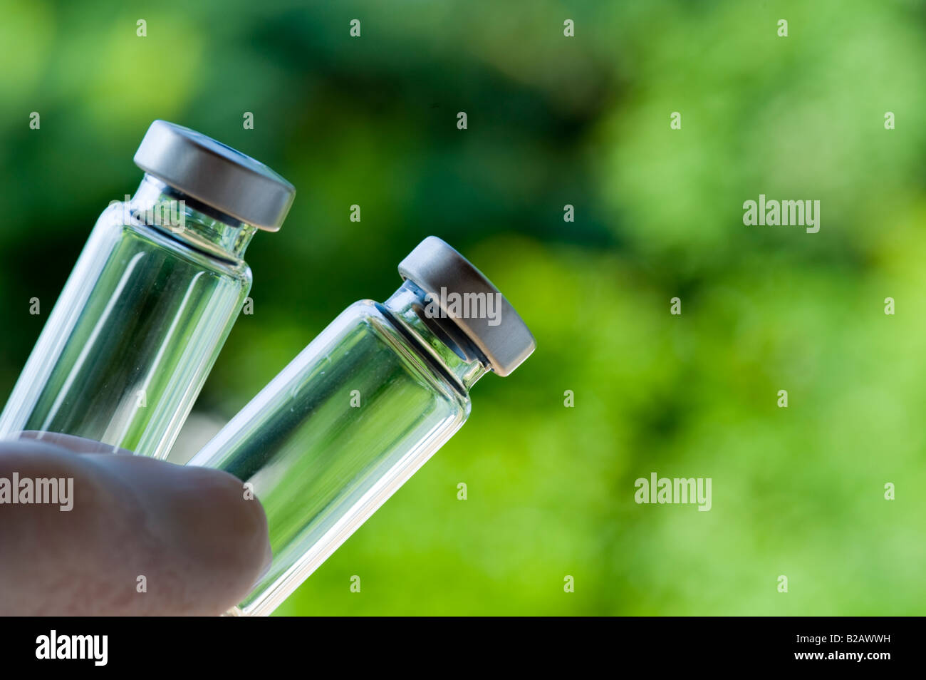 hand holding two small vials outdoors Stock Photo - Alamy