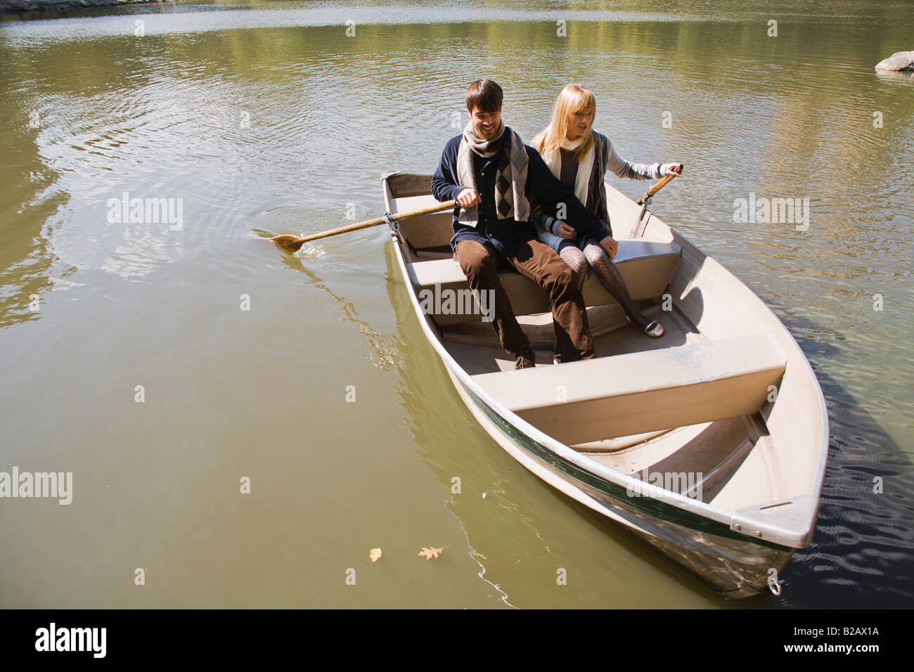 Couple rowing together in boat Stock Photo - Alamy