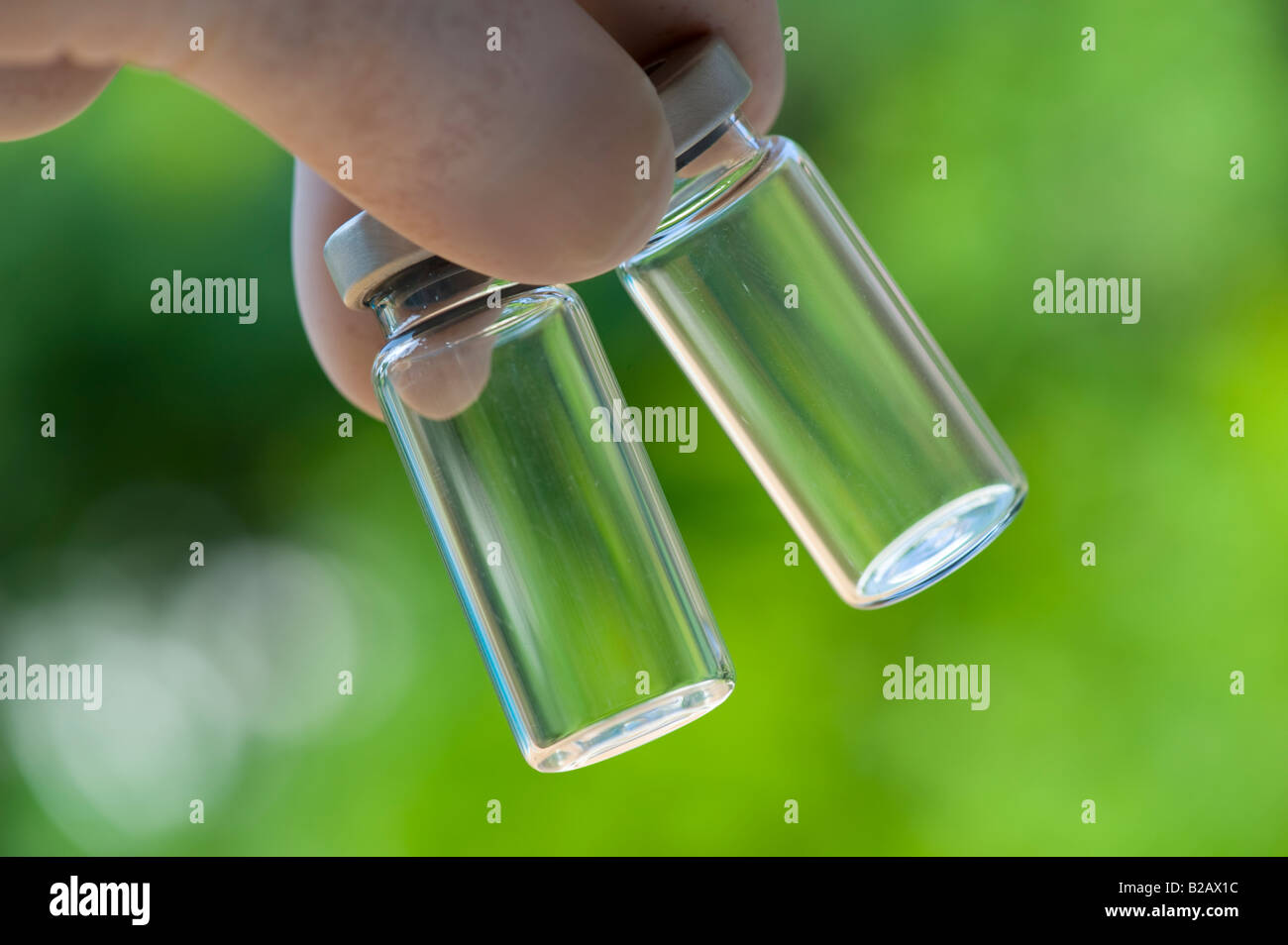 hand holding two small vials outdoors Stock Photo - Alamy