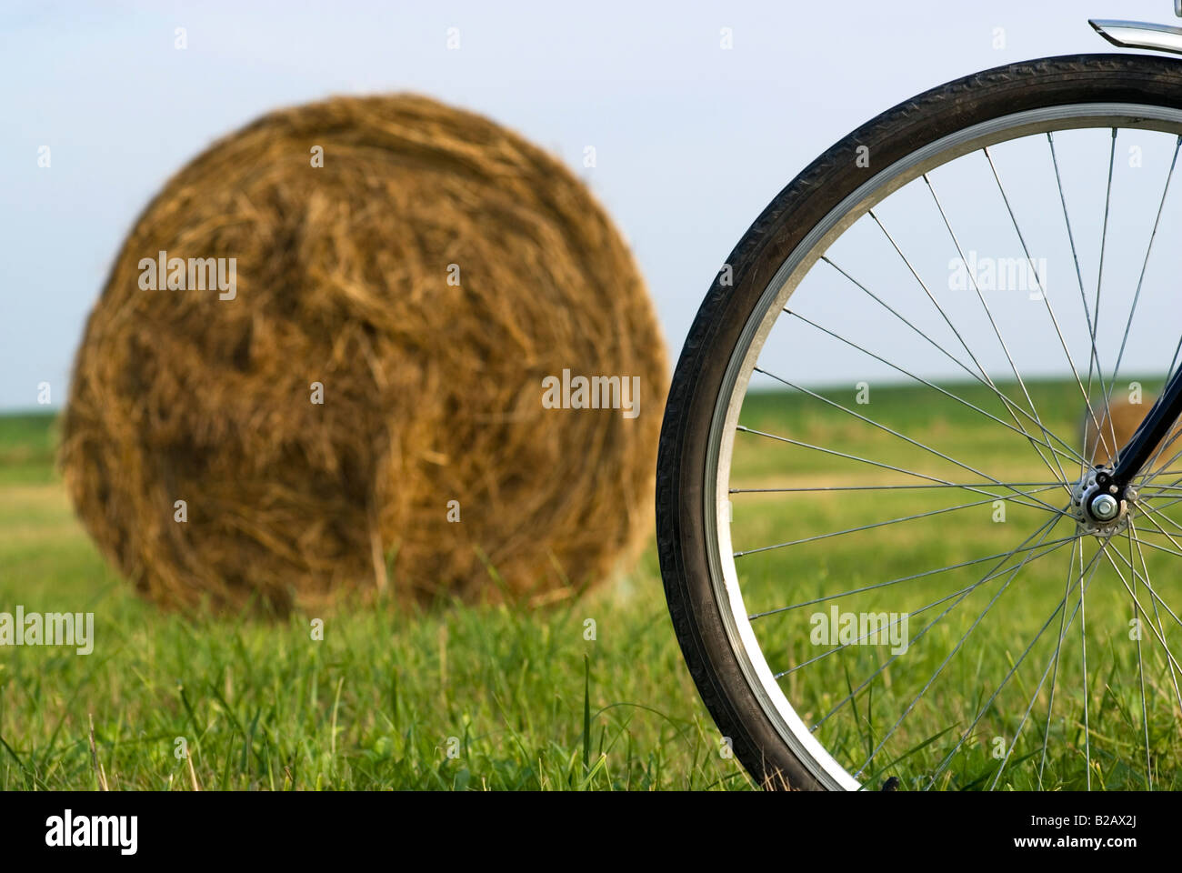 Roll shaped Hey Bale and Bike Wheel Stock Photo - Alamy