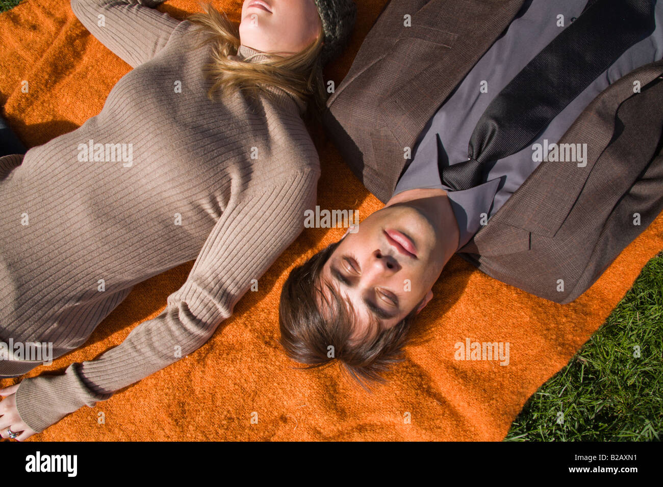 Man and woman lying on blanket in city park Stock Photo - Alamy