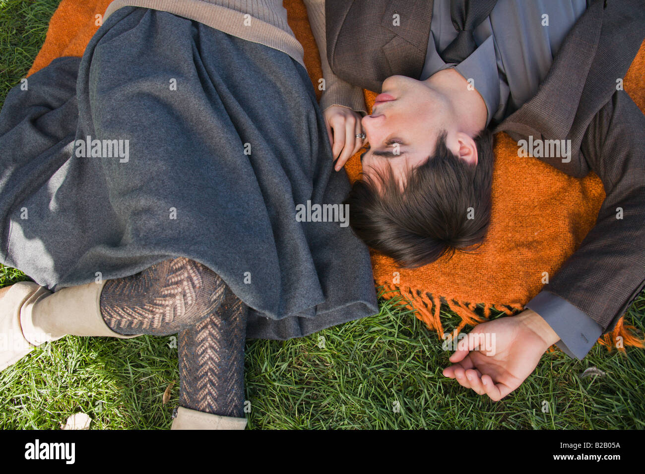 Overhead view of man and woman lying on outdoor rug Stock Photo - Alamy