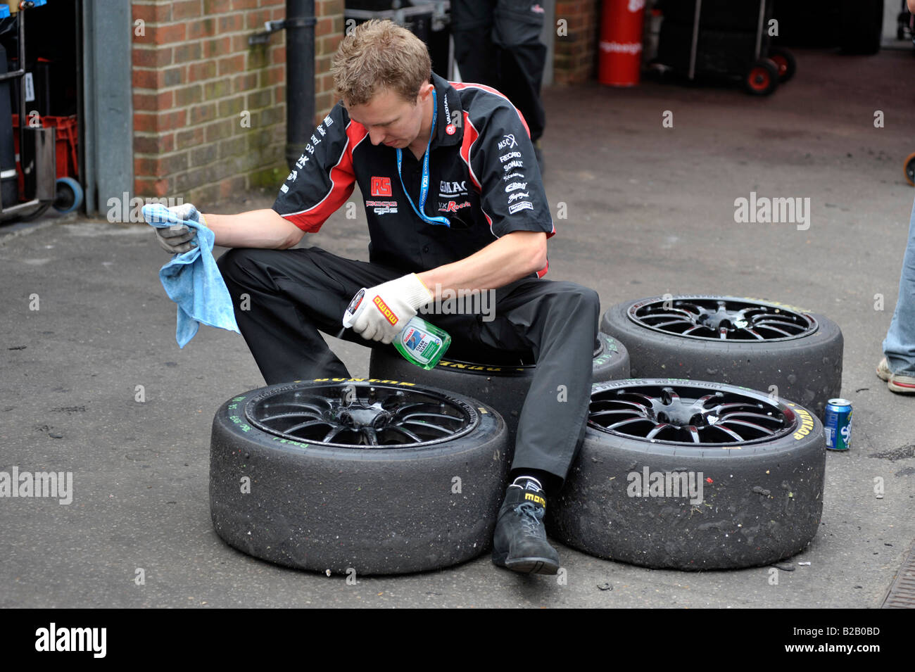mechanic cleaning touring car race wheels Stock Photo - Alamy
