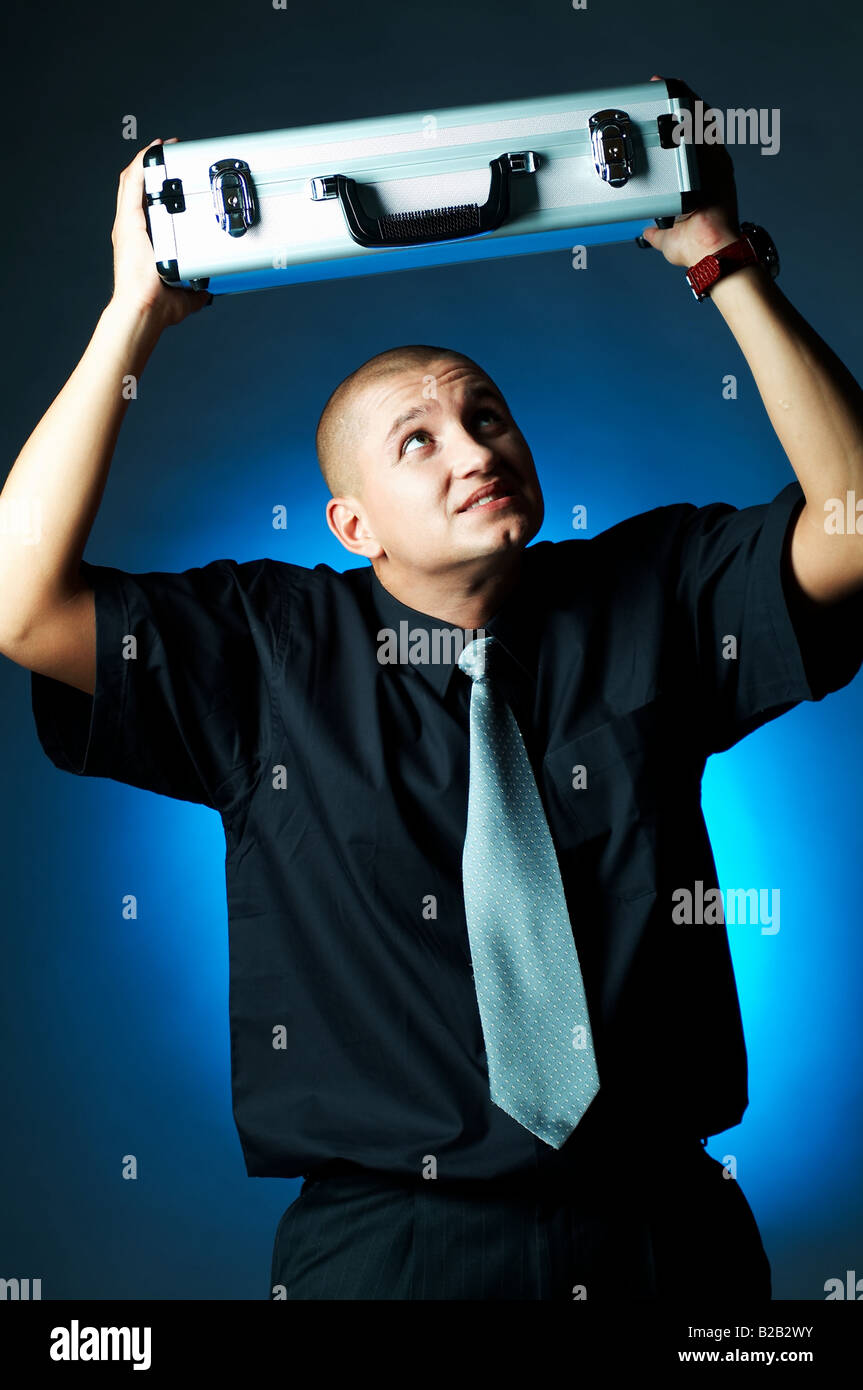 A businessman holding case over his head Stock Photo - Alamy