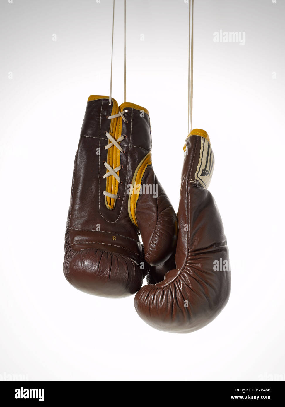 pair of brown vintage brown leather Everlast boxing gloves hanging with ...