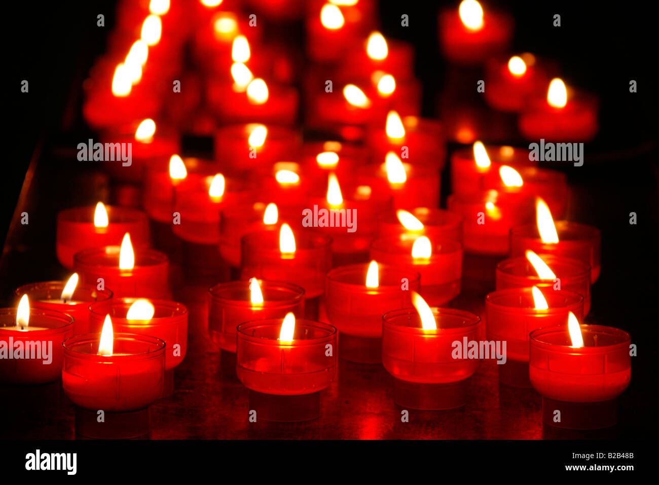 many lit candles in dark room in church Stock Photo - Alamy