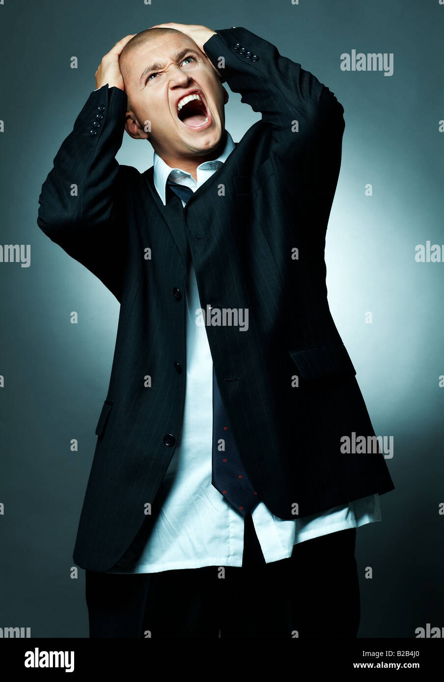 A Young businessman screaming Stock Photo - Alamy