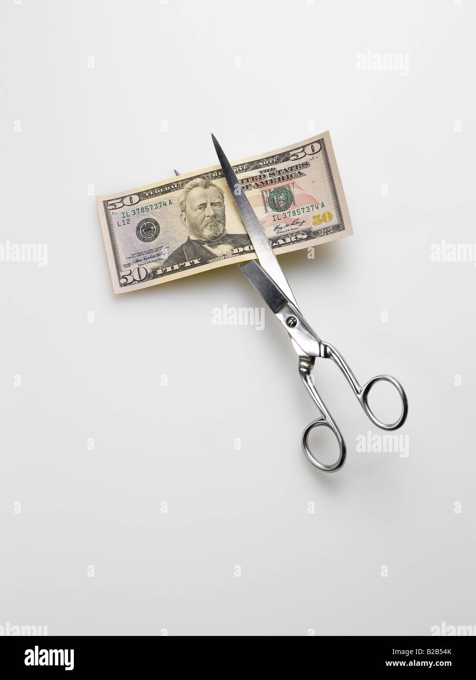 scissors cutting American 5 five dollar bill money on white background ...