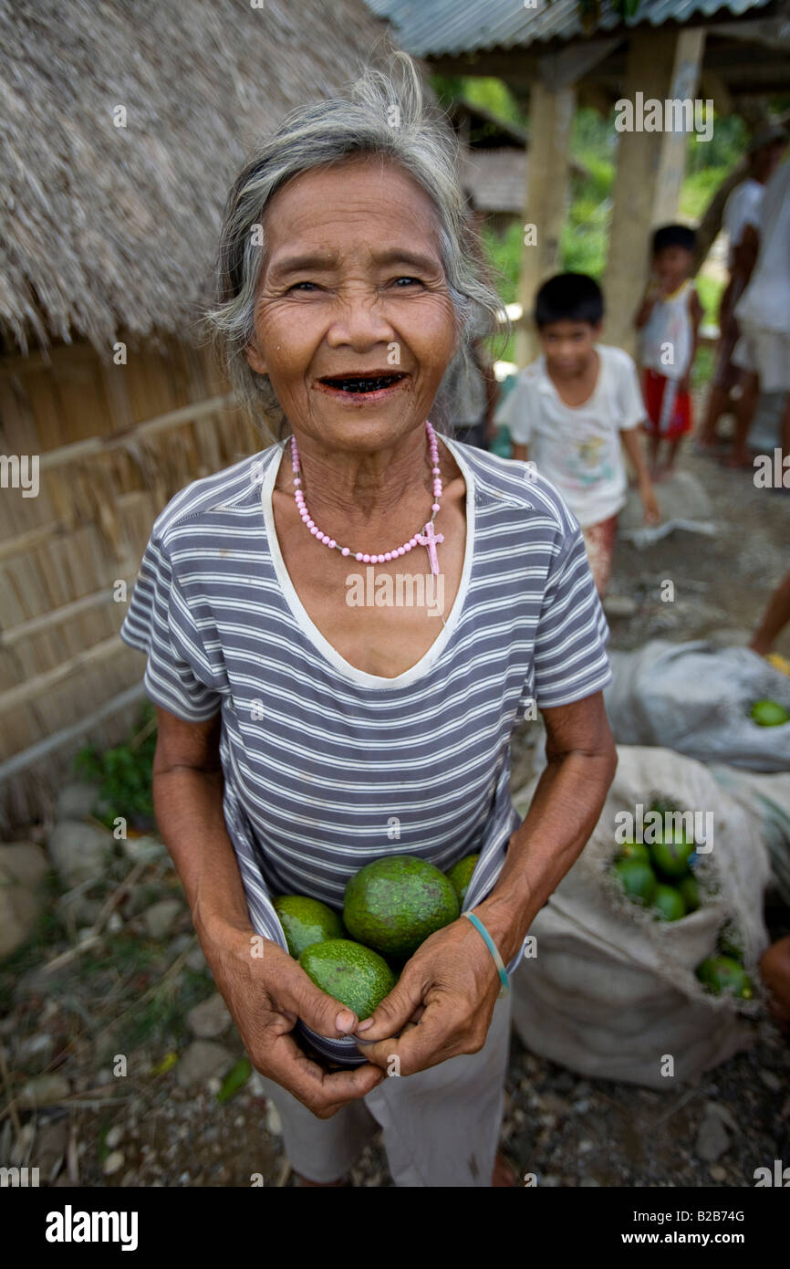 A Mangyan woman with some avocados from the Panaytayan community near ...