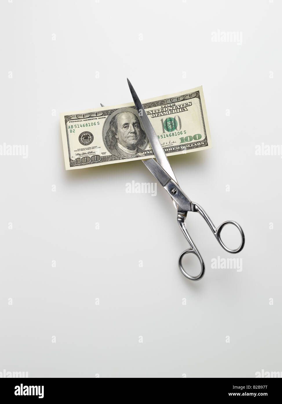scissors cutting American 100 hundred dollar bill money on white ...