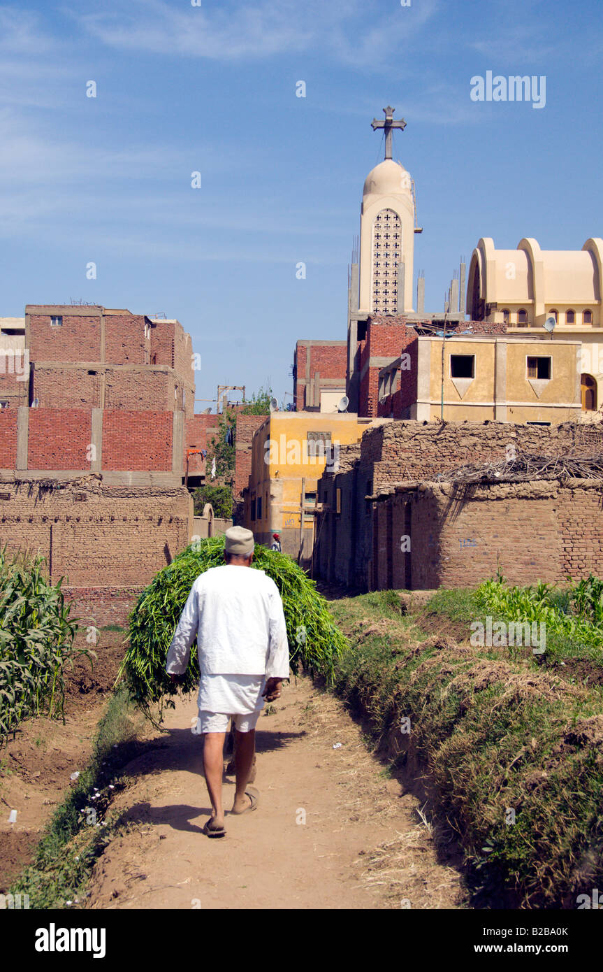 A man walking on a path through a village on Gold Island in Cairo Egypt ...