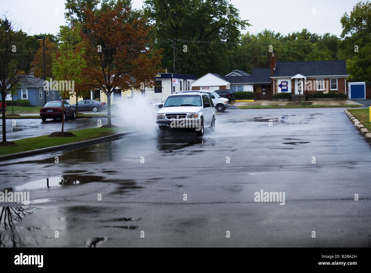 Ford Explorer driving through puddles of rain Stock Photo - Alamy
