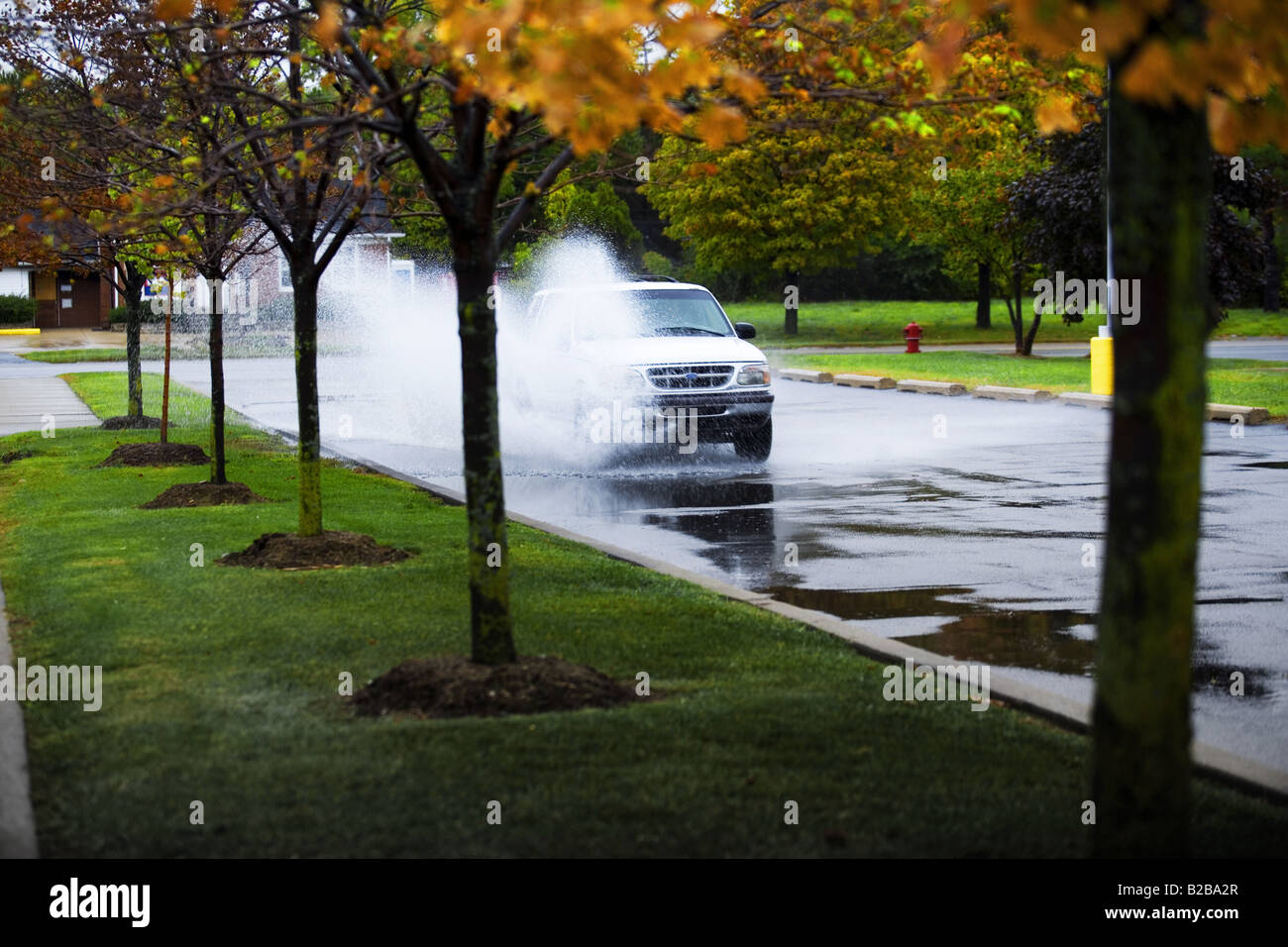 Ford Explorer driving through puddles of rain Stock Photo - Alamy