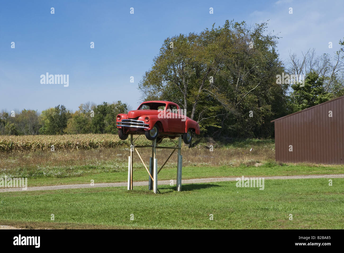 Vintage car raised on posts Stock Photo - Alamy