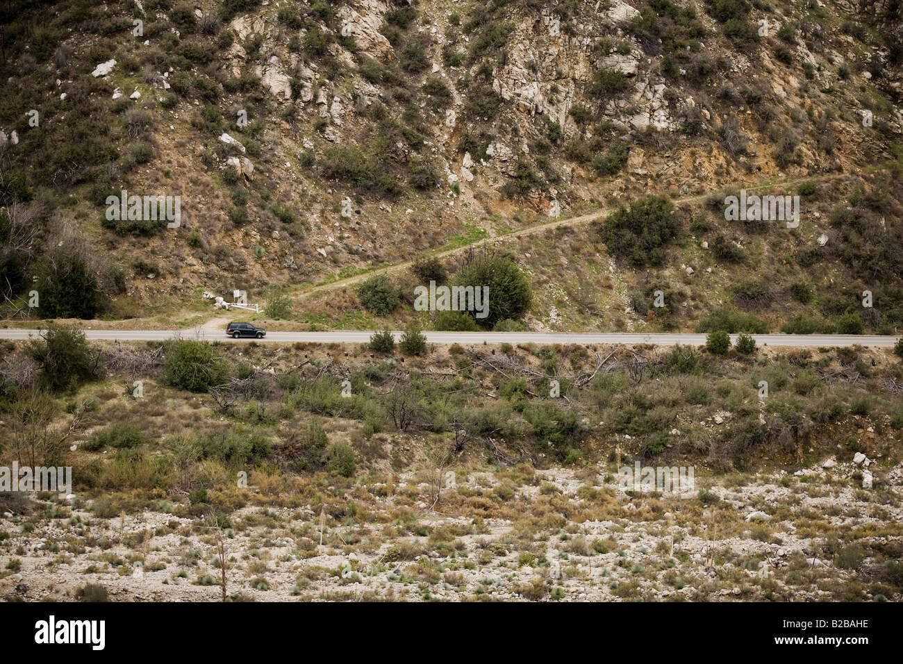 View of car driving along rural road Stock Photo - Alamy