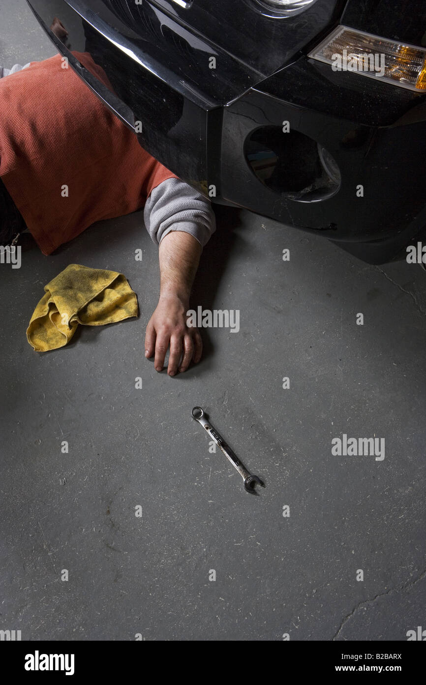 Auto mechanic underneath car Stock Photo - Alamy