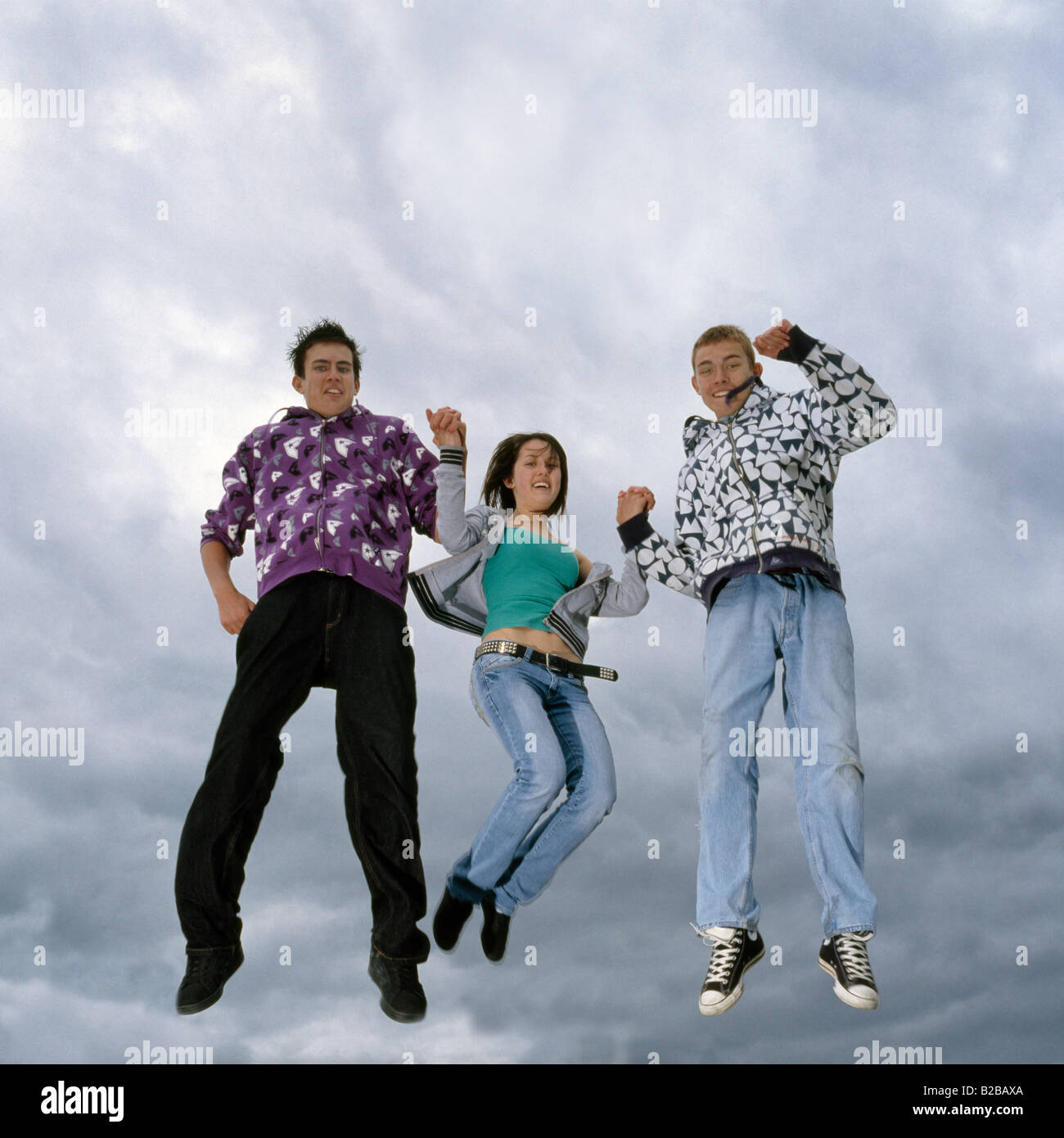 Three teenagers jumping for joy Stock Photo - Alamy
