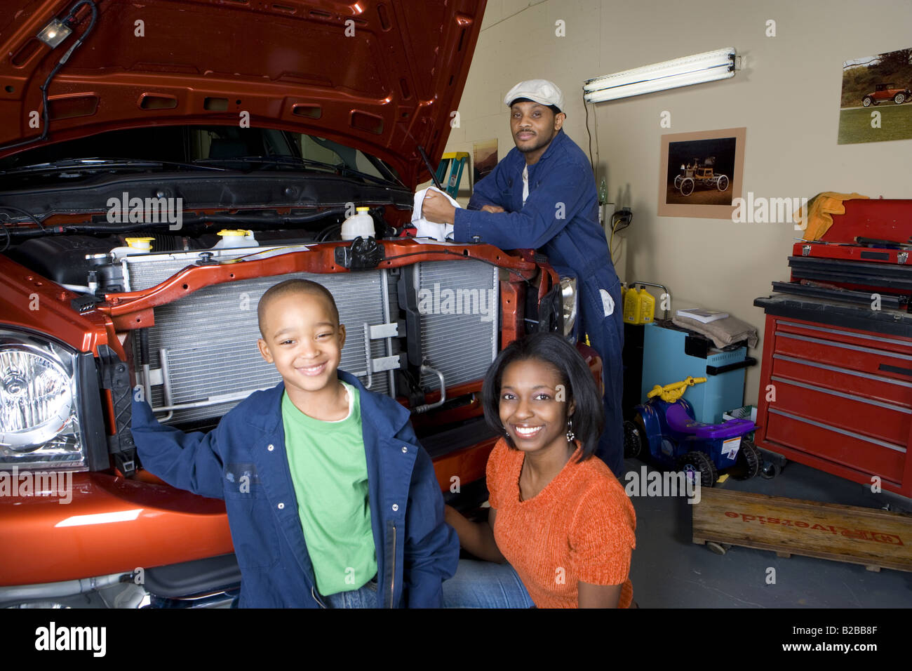 Man inspects his wife's greasy jeans in garage Stock Photo - Alamy