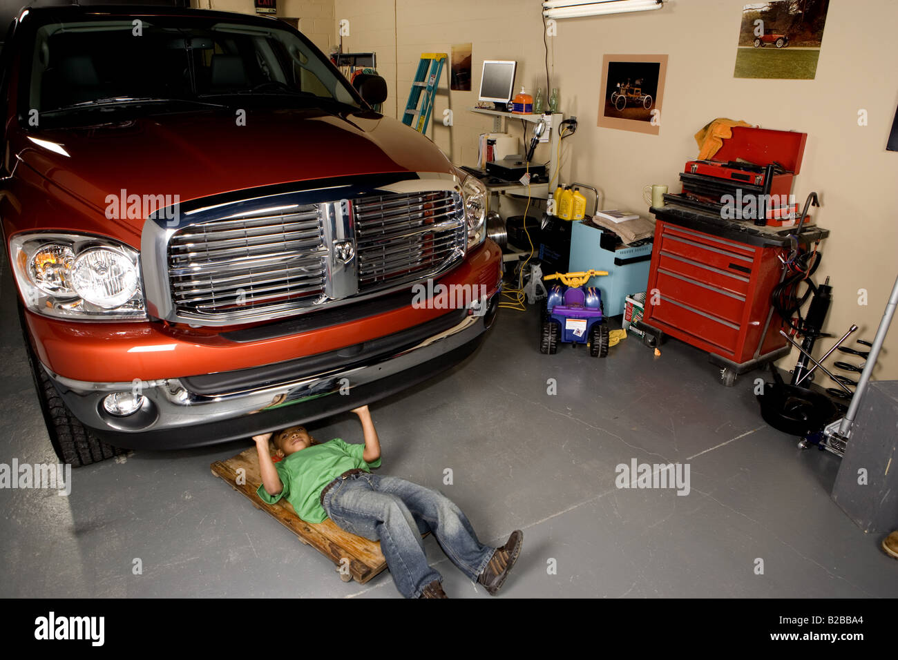 Woman underneath car hi-res stock photography and images - Alamy