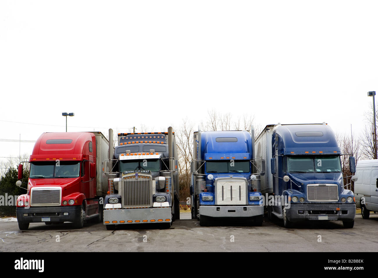 Row of trucks parked at truckstop Stock Photo - Alamy