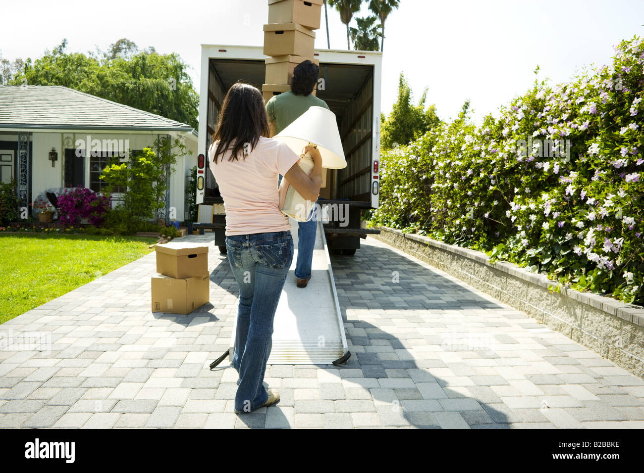Young couple moving household items in to truck Stock Photo - Alamy
