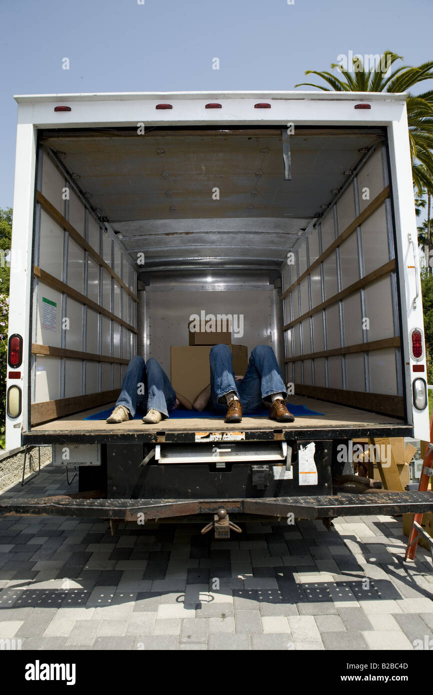 Feet of young couple relaxing in back of moving truck Stock Photo - Alamy