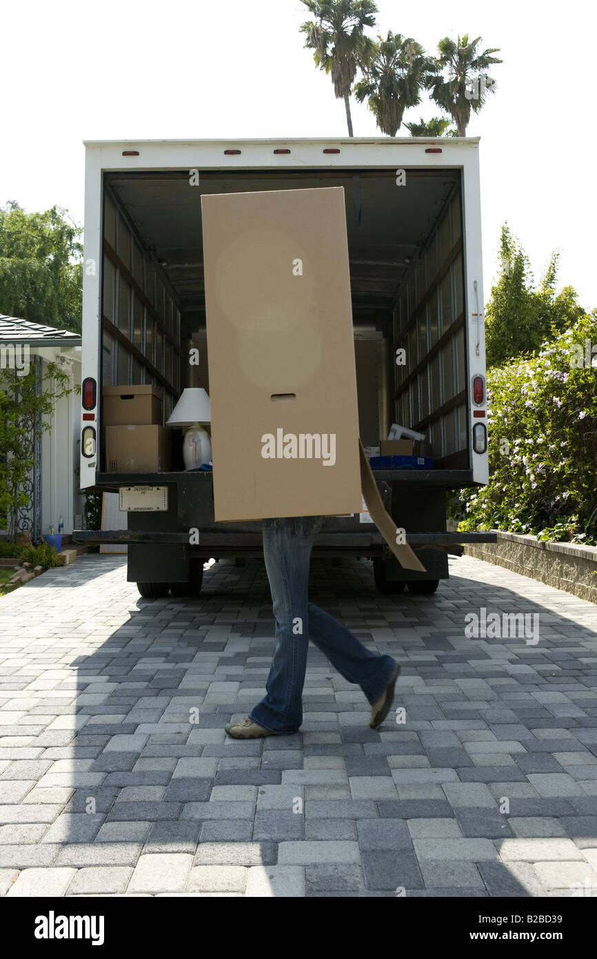 Young woman with moving box on their heads Stock Photo - Alamy