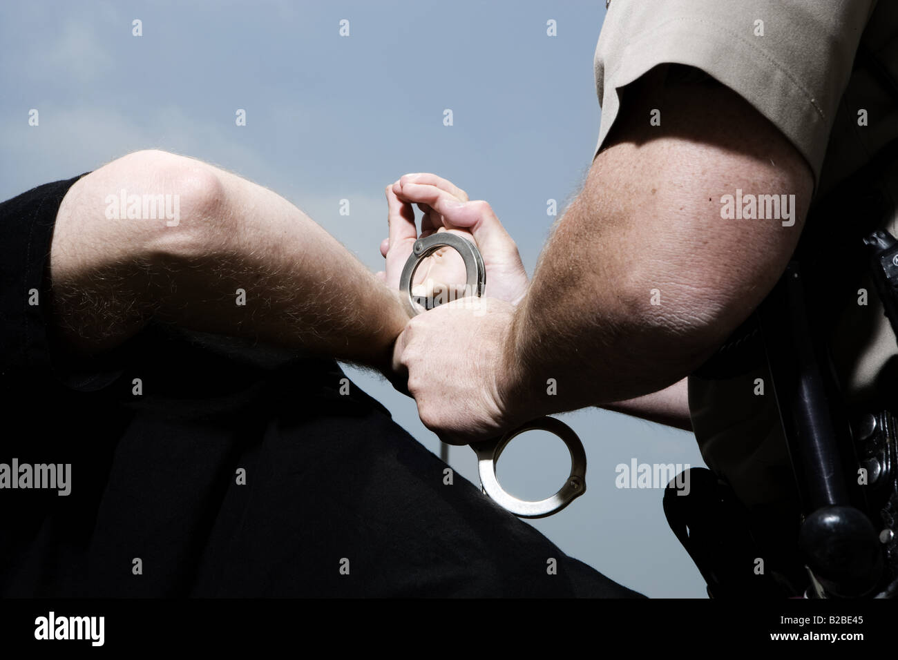 Handcuffed arms hi-res stock photography and images - Alamy