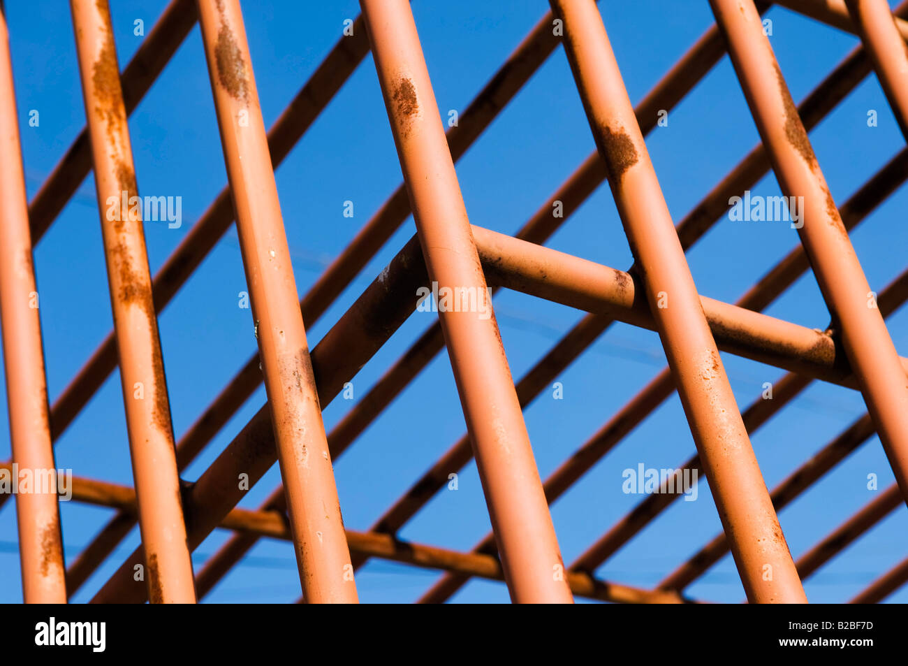 Rusty cage detail painted in red against the sky Stock Photo - Alamy