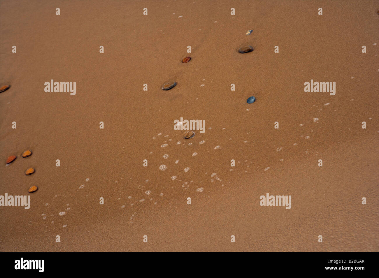 Pebbles and Sand on a beach Stock Photo - Alamy