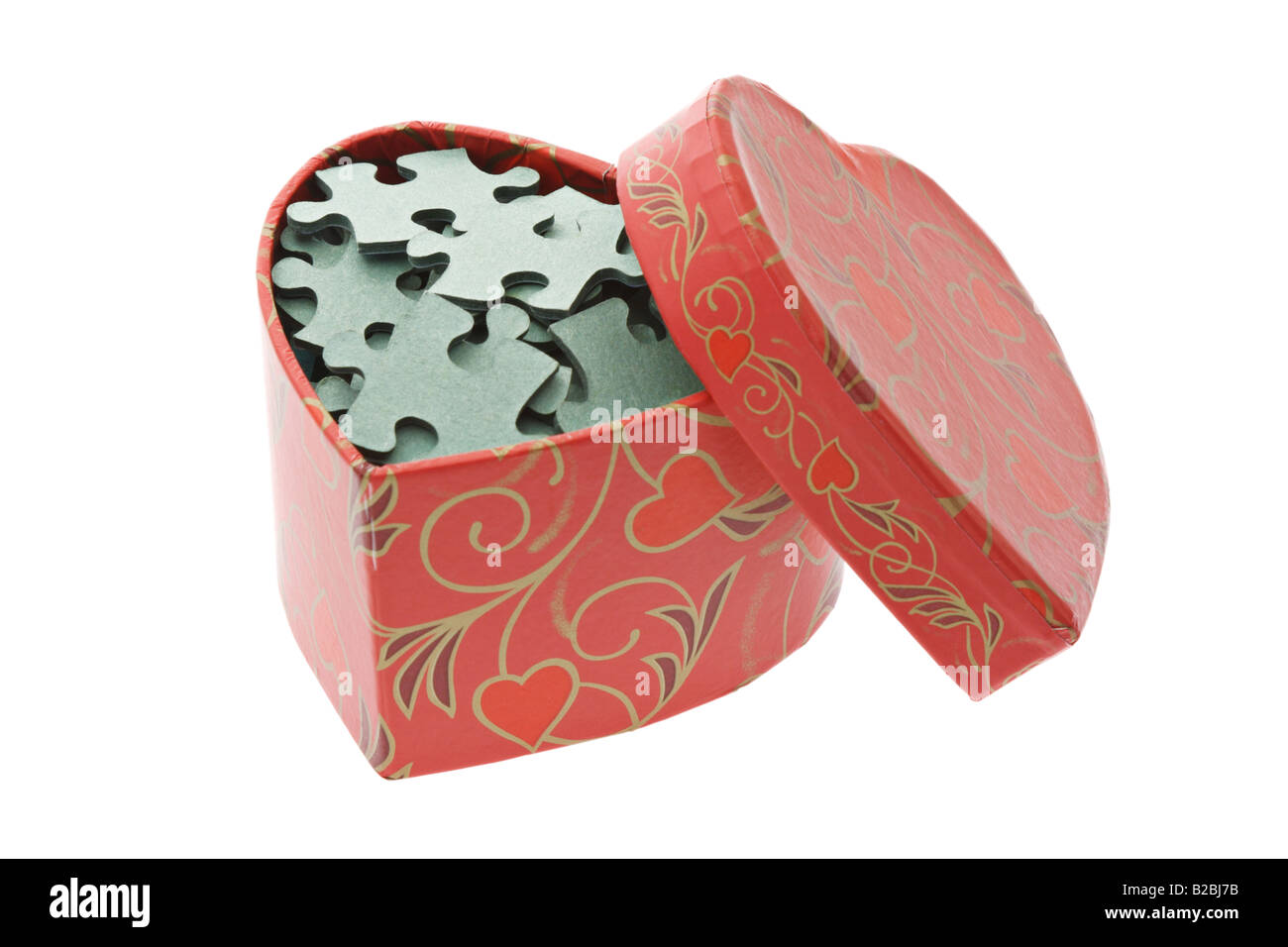 Jigsaw puzzles in heart shape gift box on white background Stock Photo ...