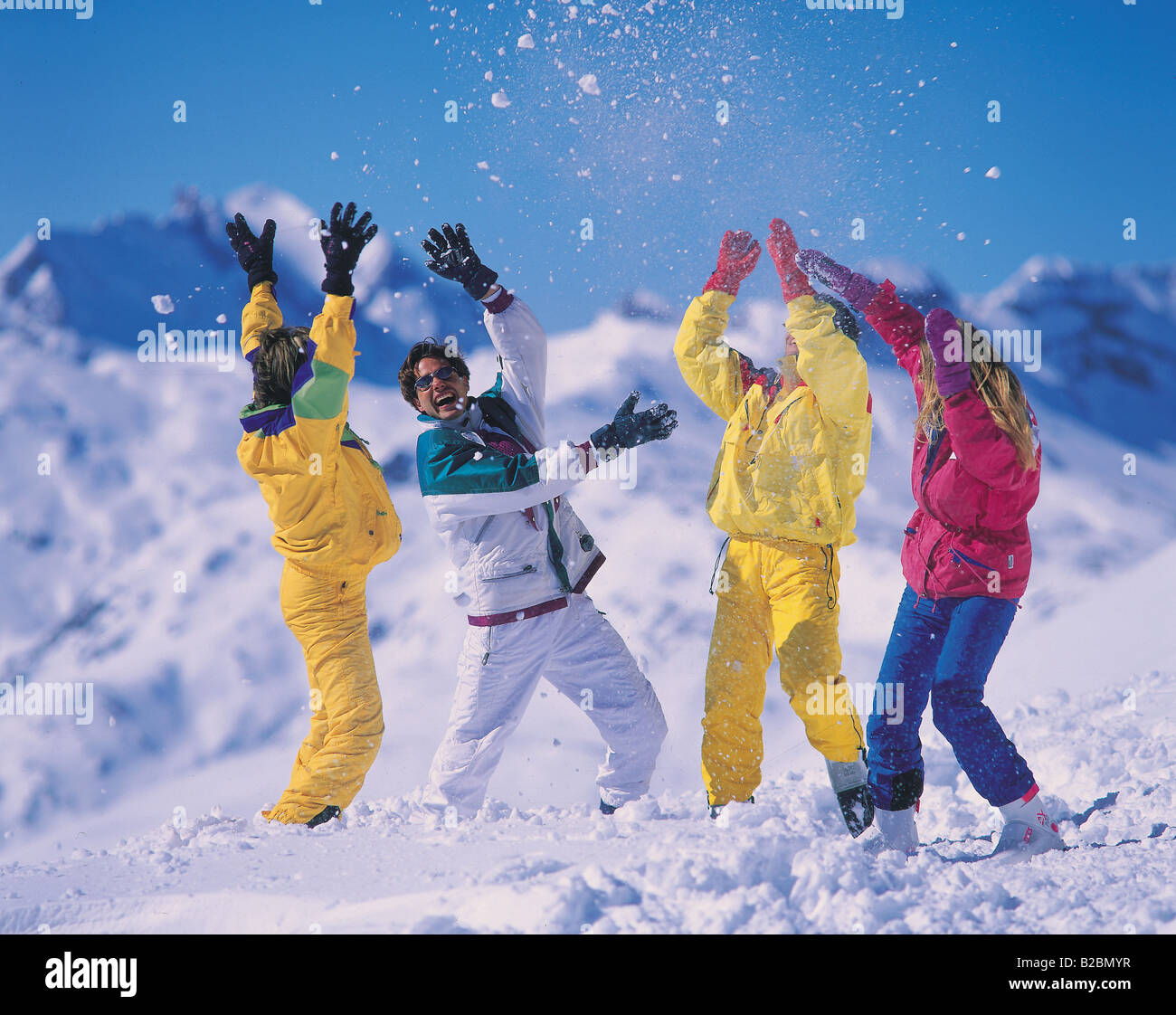 Group having snowball fight Stock Photo - Alamy