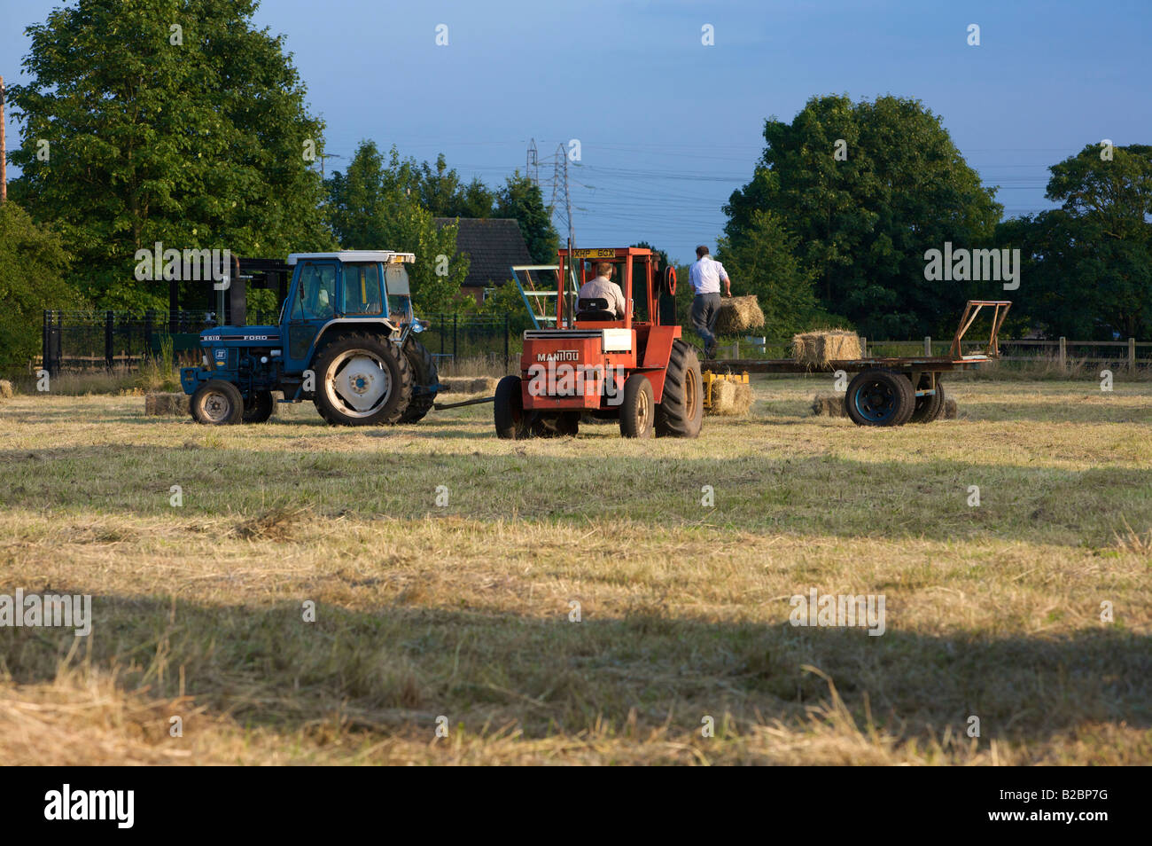 Loading Hay Bales Stock Photo - Alamy