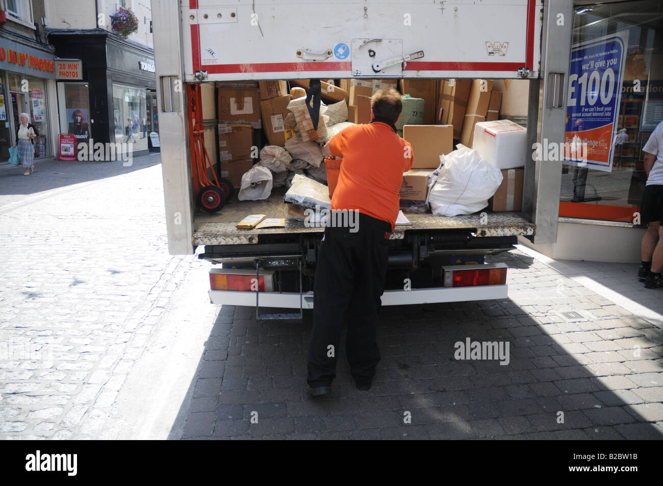 A man unloading a van Stock Photo - Alamy
