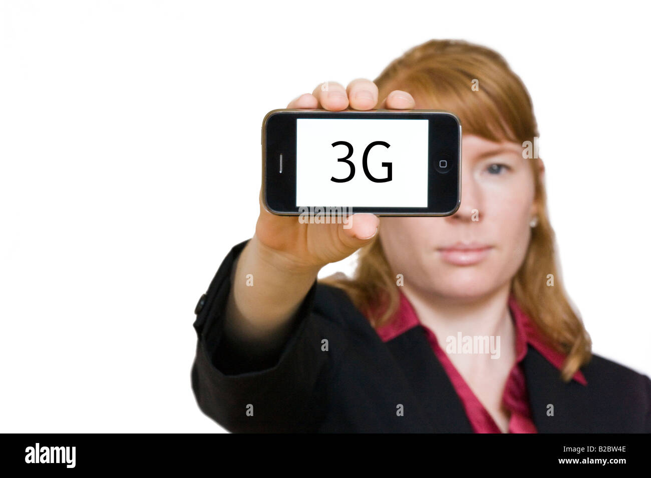 A female model in business attire displays an Apple 3G iPhone Stock ...