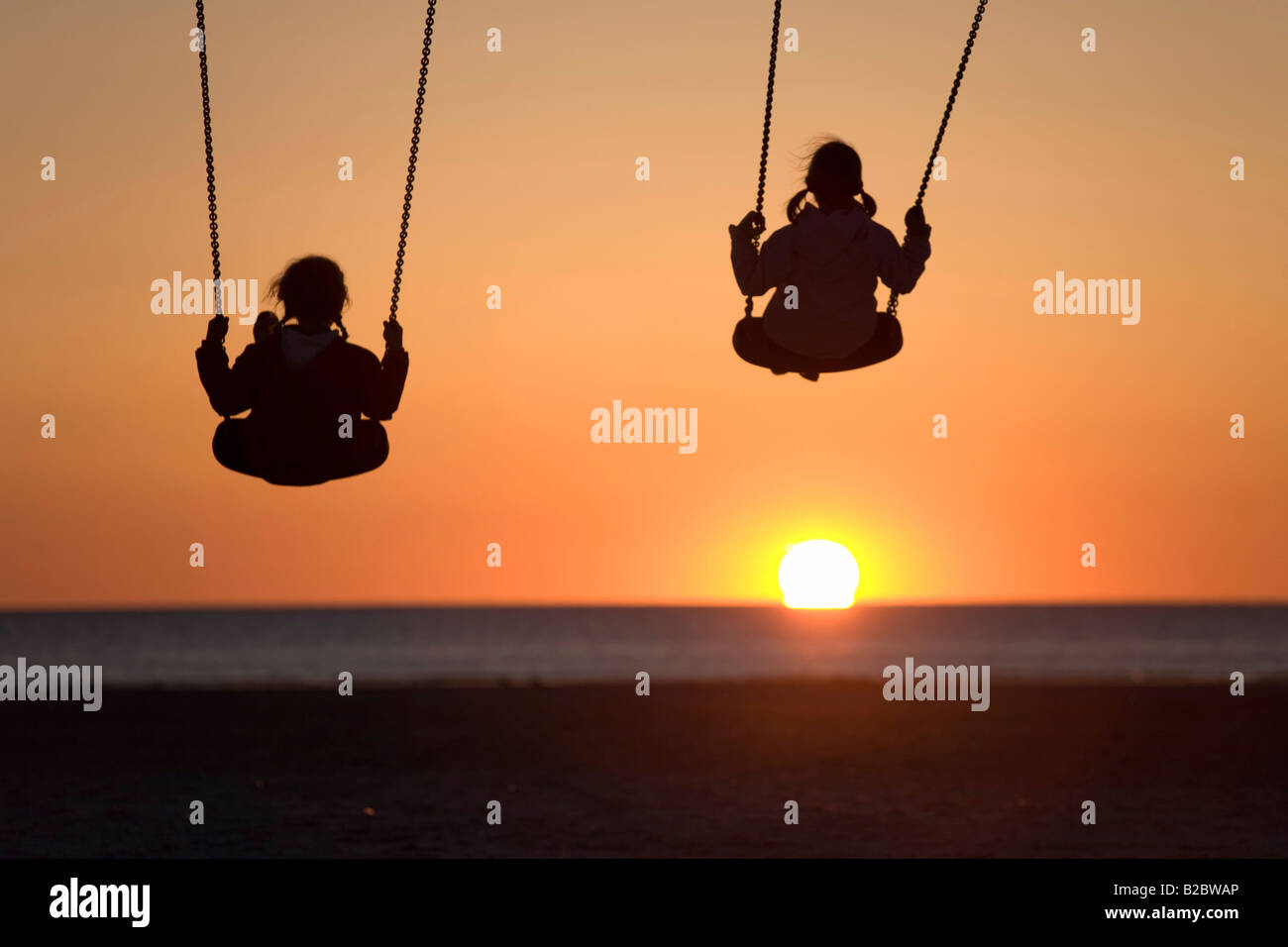 Two kids watching sunset hi-res stock photography and images - Alamy