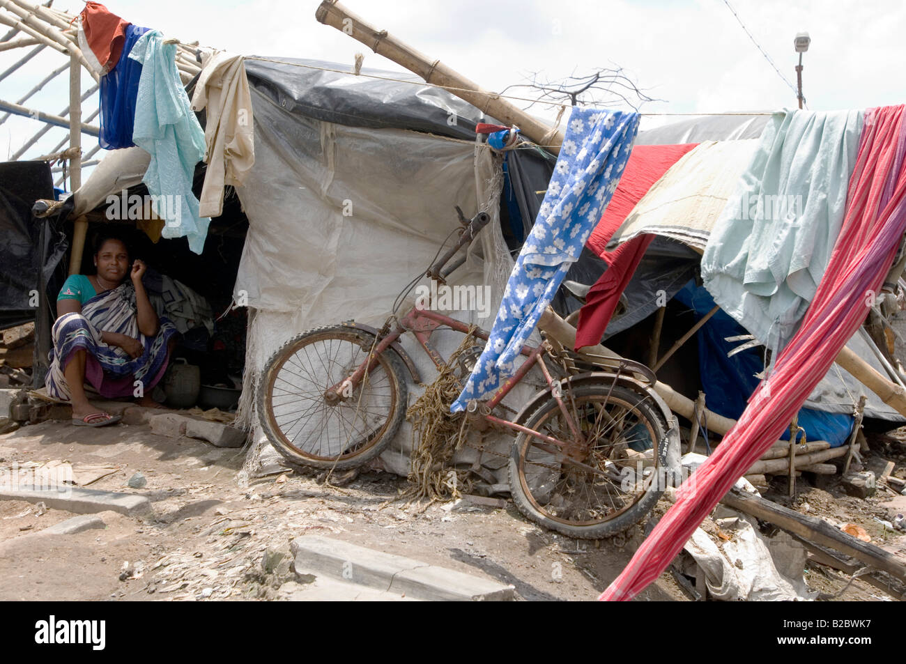 Woman sitting in the entrance of her hut in the slums of the Topsia ...