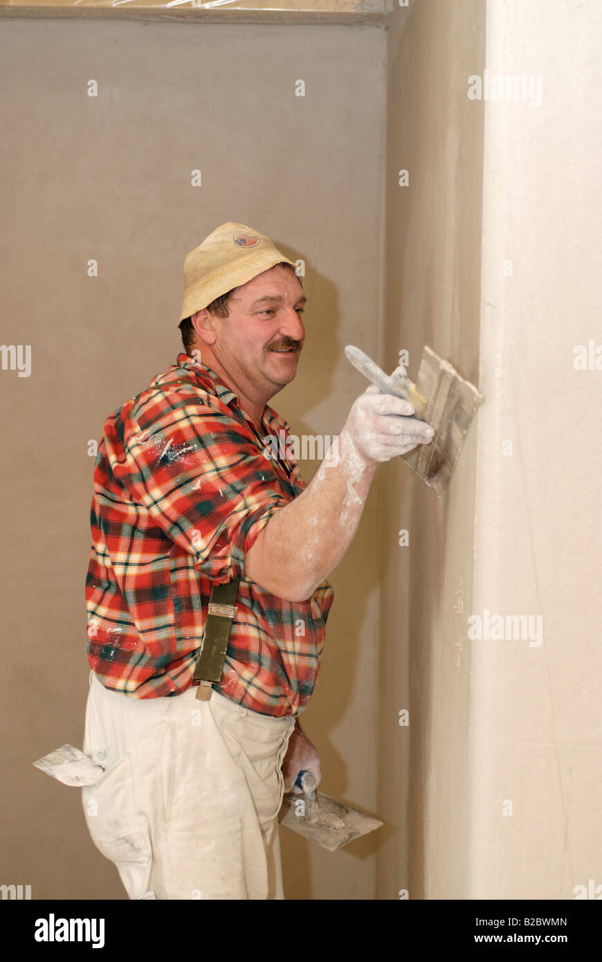 Plasterer at work, wave-like plaster, house construction, brickwork ...