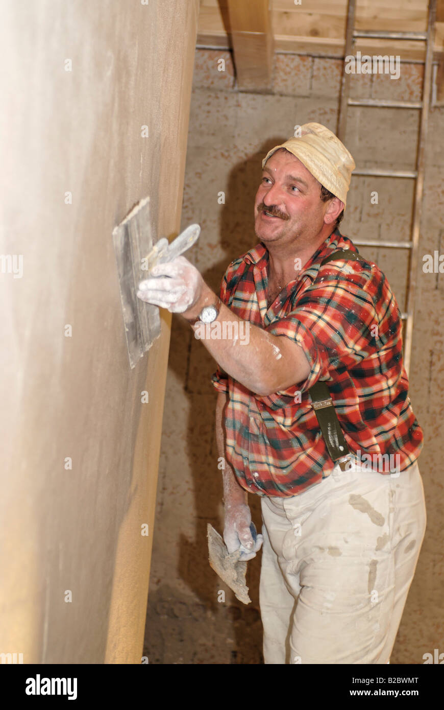 Plasterer at work, wave-like plaster, house construction, brickwork ...