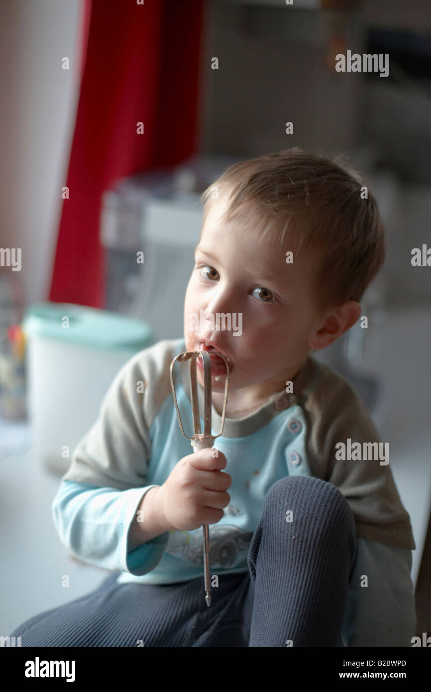 Boy nibbling in a kitchen Stock Photo - Alamy