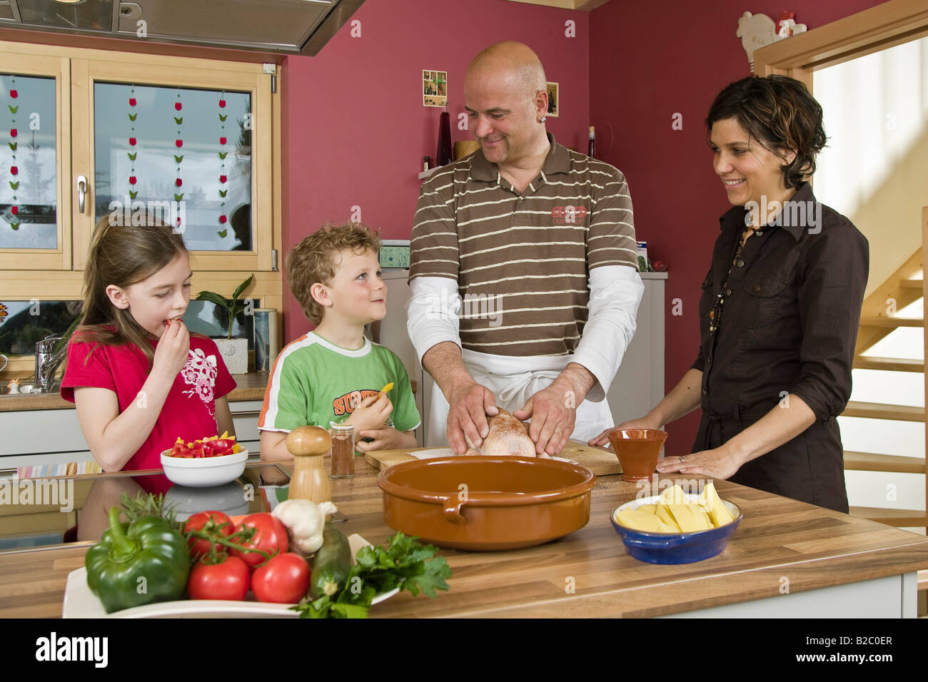 Parents, children, cooking together Stock Photo - Alamy