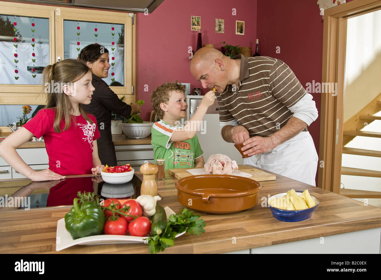 Parents, children, cooking together Stock Photo - Alamy