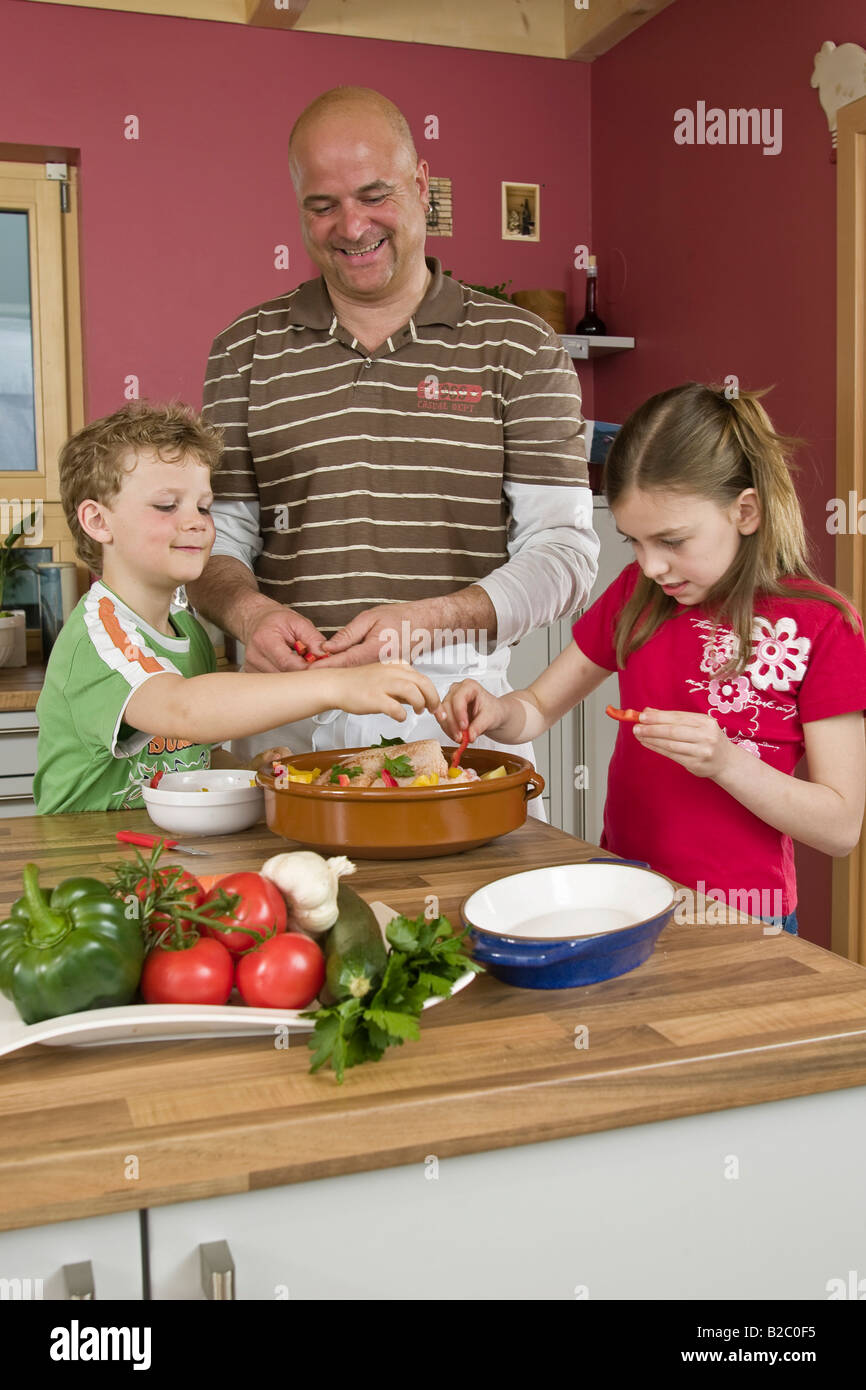 Father, children, cooking together Stock Photo - Alamy