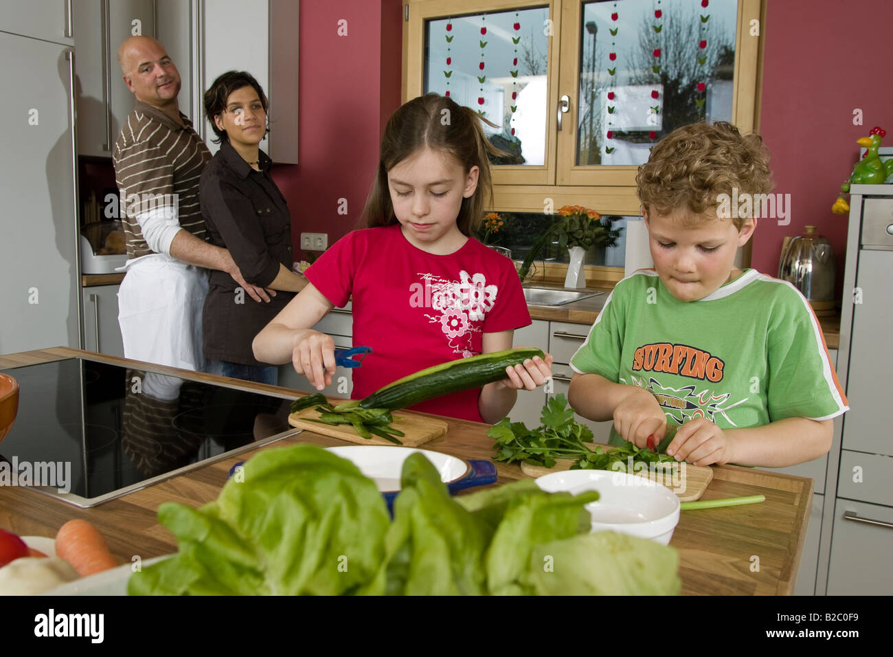 Parents, children, cooking together Stock Photo - Alamy