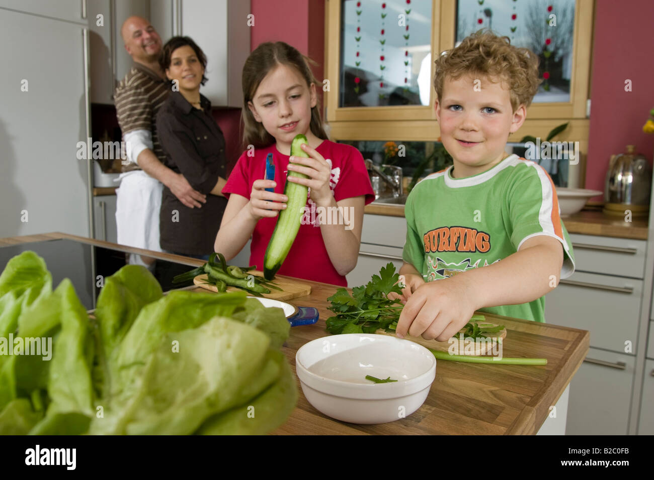 Parents, children, cooking together Stock Photo - Alamy