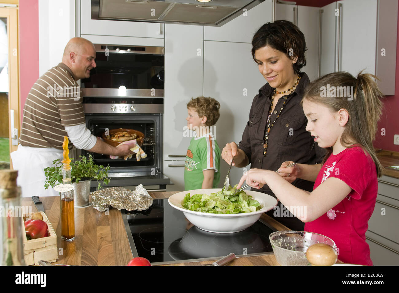 Parents and children cooking together Stock Photo - Alamy